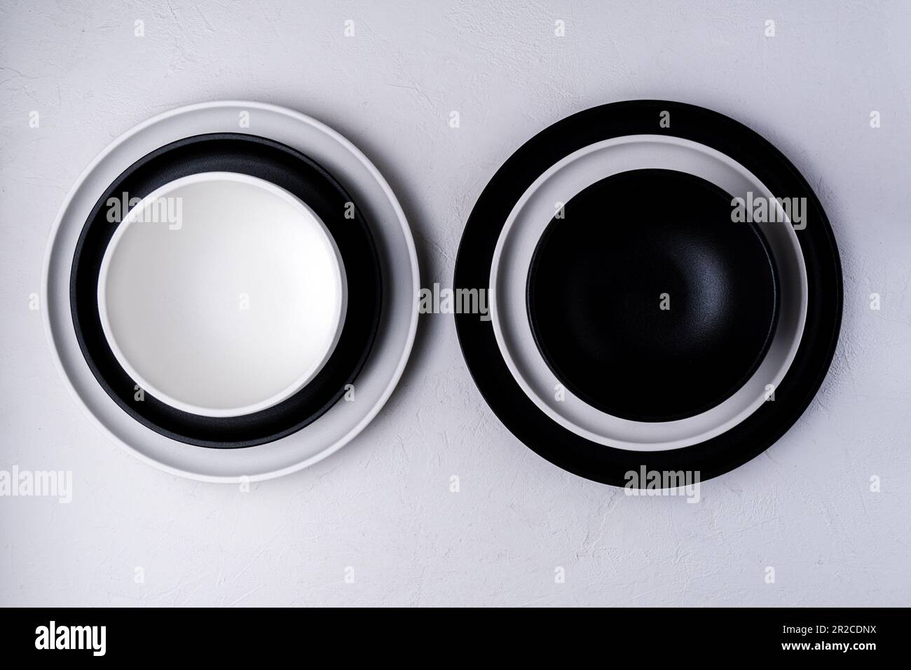 Empty ceramic plate, black and white on a concrete white background ...