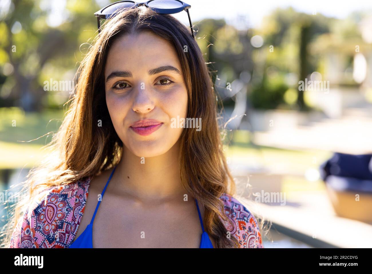 Portrait of smiling caucasian fit woman with sunglasses on head ...