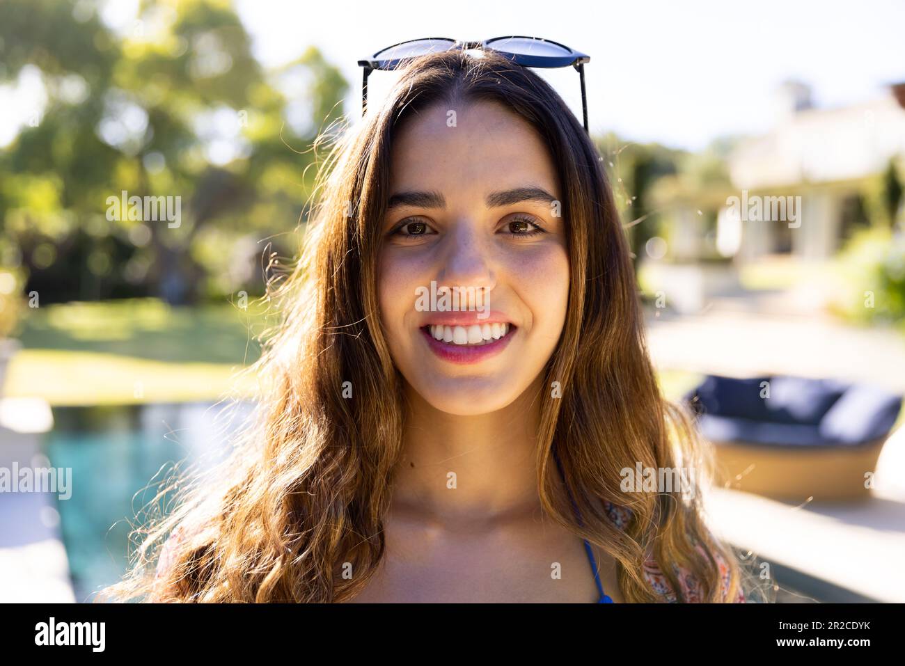 Portrait Of Smiling Caucasian Fit Woman With Sunglasses On Head