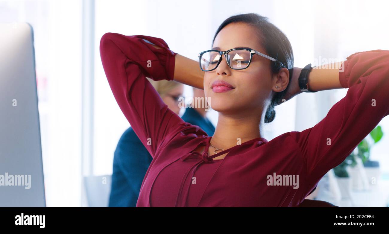 Relax, computer and a business woman done with her tasks for the day in ...