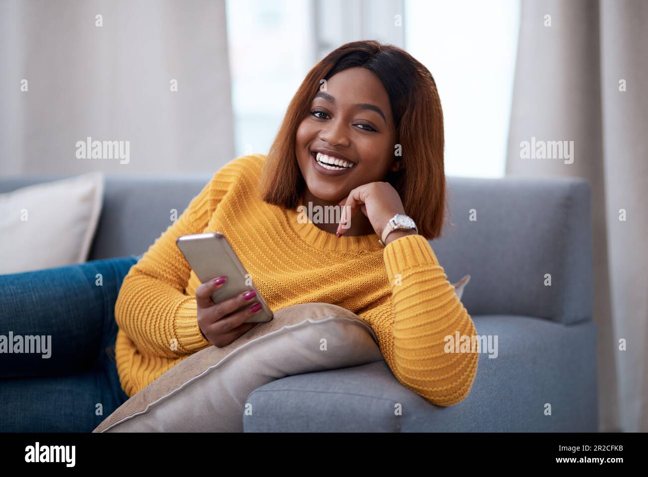 Black woman using phone, chat on social media and laughing, relax at ...
