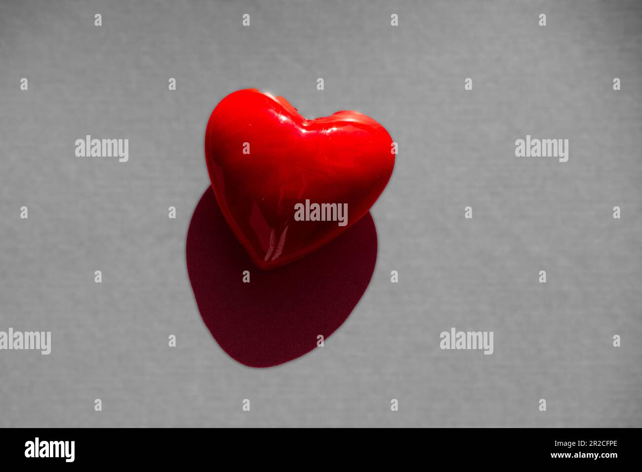 red glass heart in front of colorless background Stock Photo - Alamy