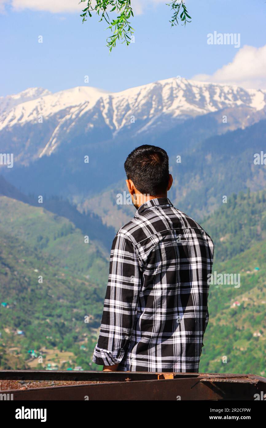 man looking at snow capped mountain, the fresh mountain air and ...