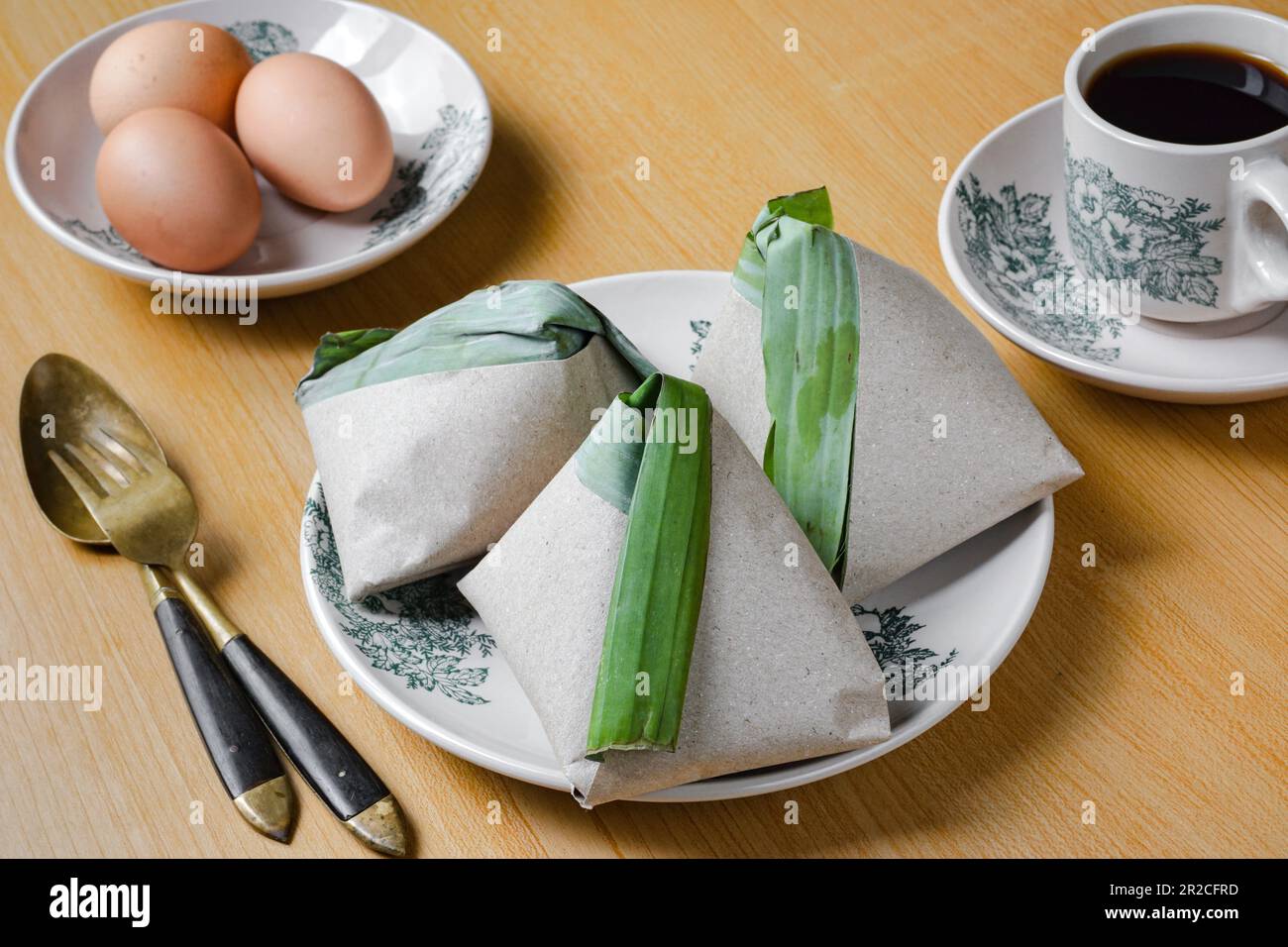 Asian food Nasi Lemak is a rice dish infused with coconut milk. Wrap in ...