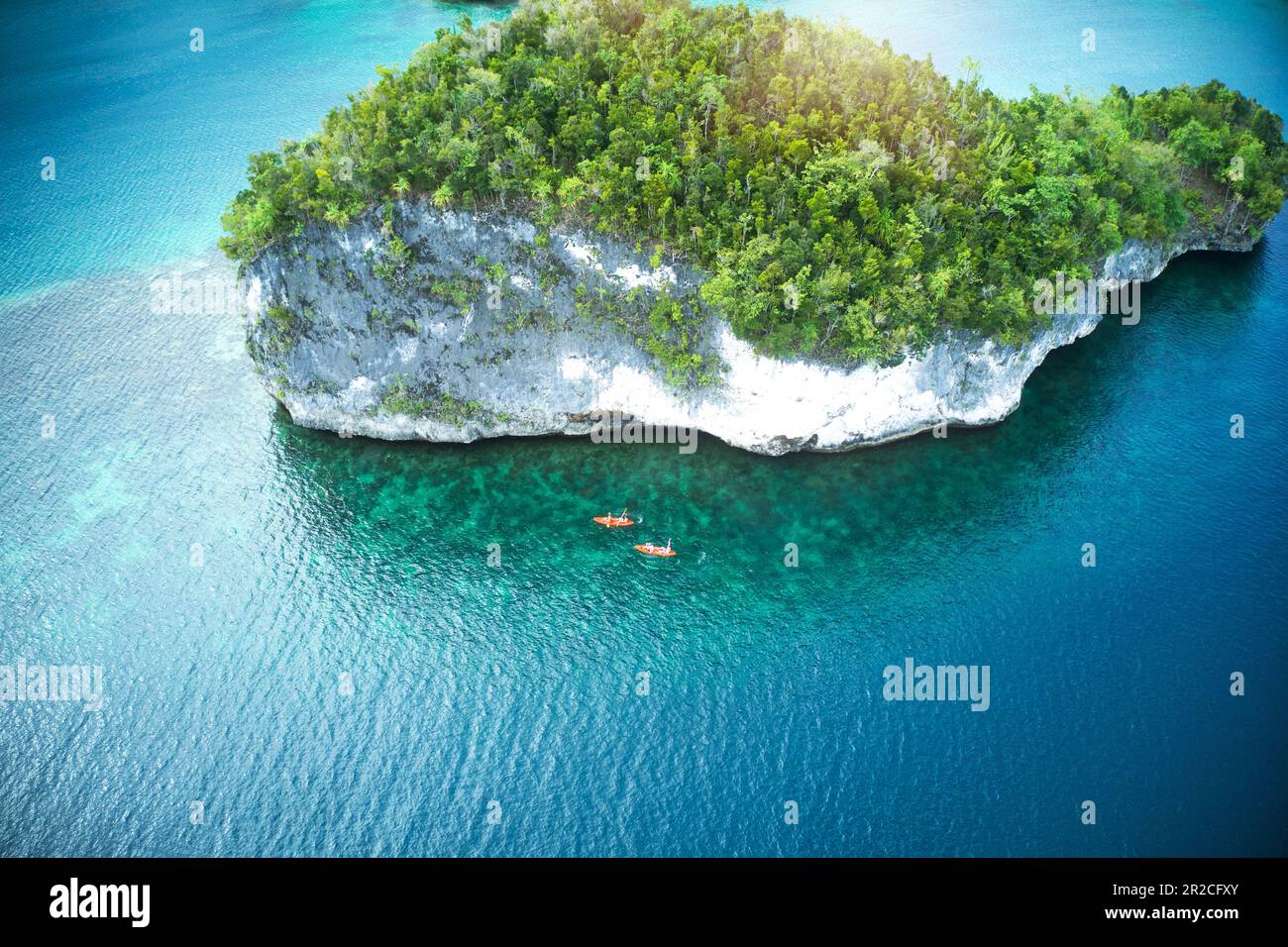 Drone, island and water adventure with people in kayak for travel ...