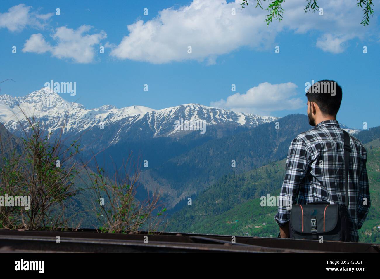 man looking at snow capped mountain, the fresh mountain air and ...