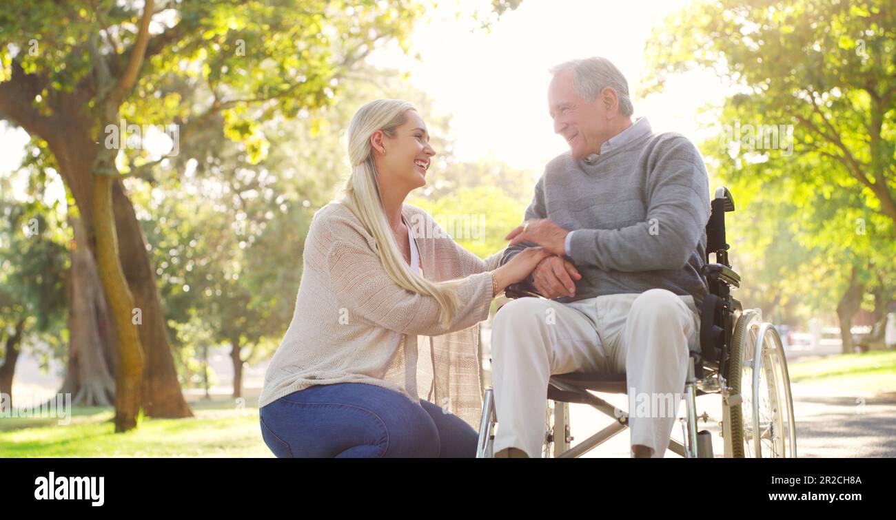 Happy, talking and man in wheelchair with a woman in nature for care ...