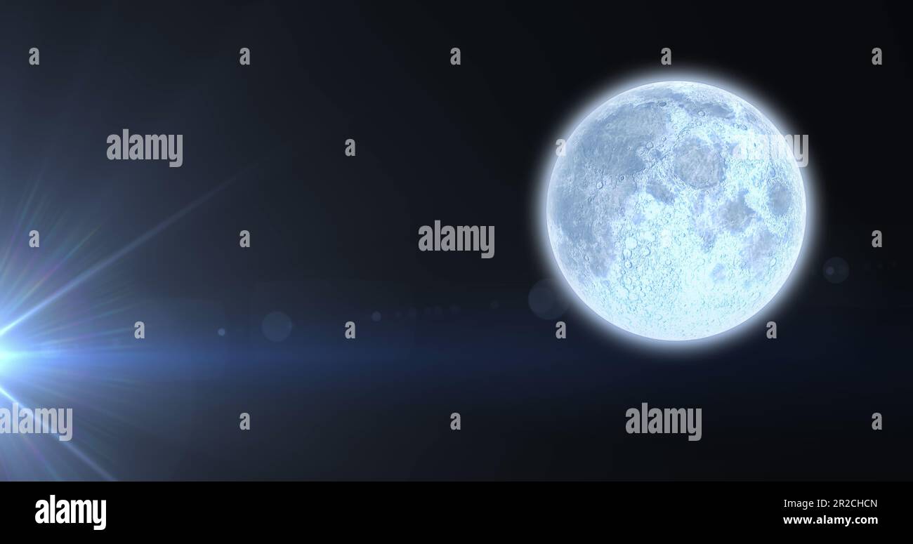 Composition of glowing light over full moon and copy space on blue ...