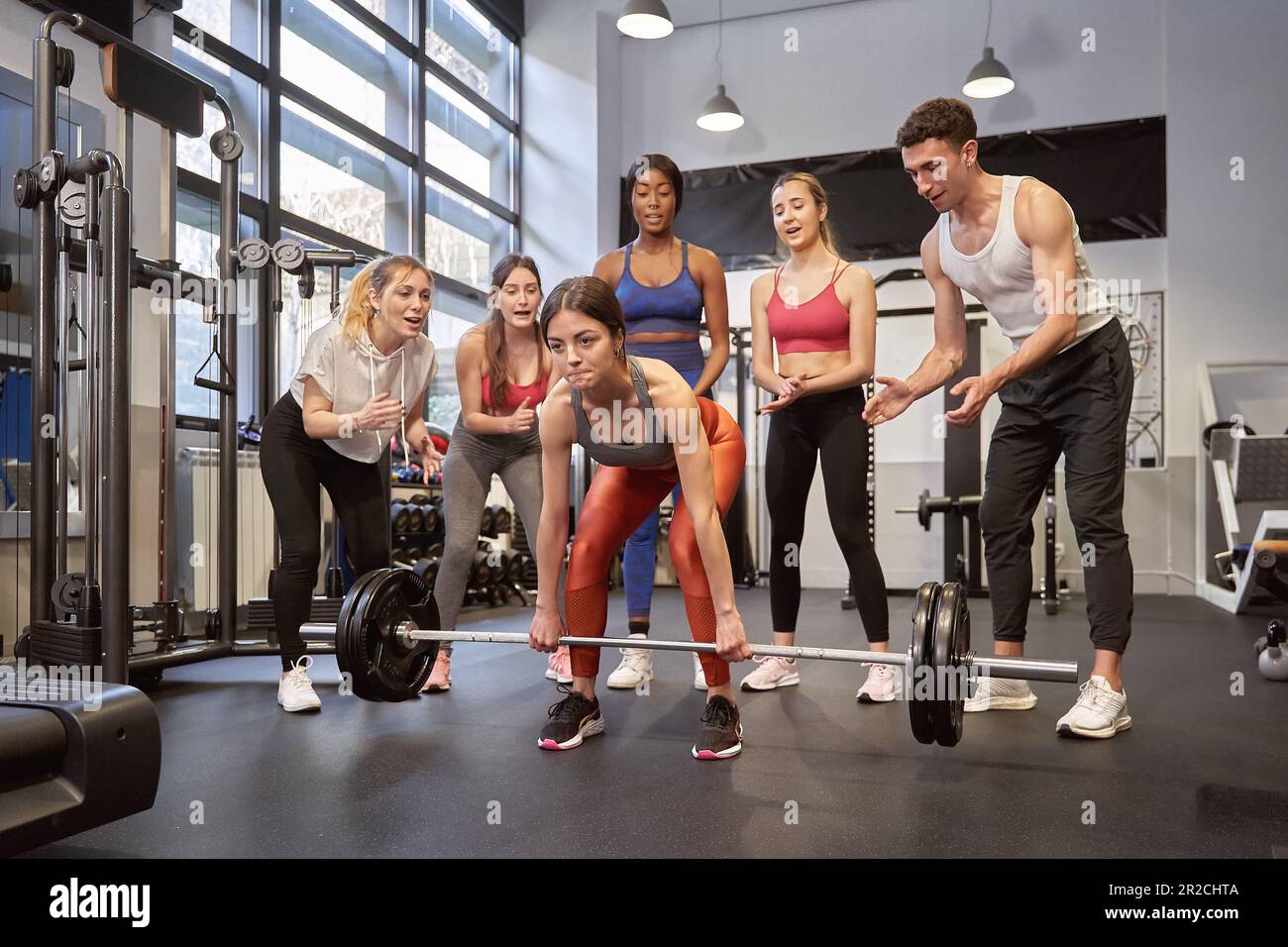 Supportive Group of Friends Encouraging and Cheering On a Woman as She ...