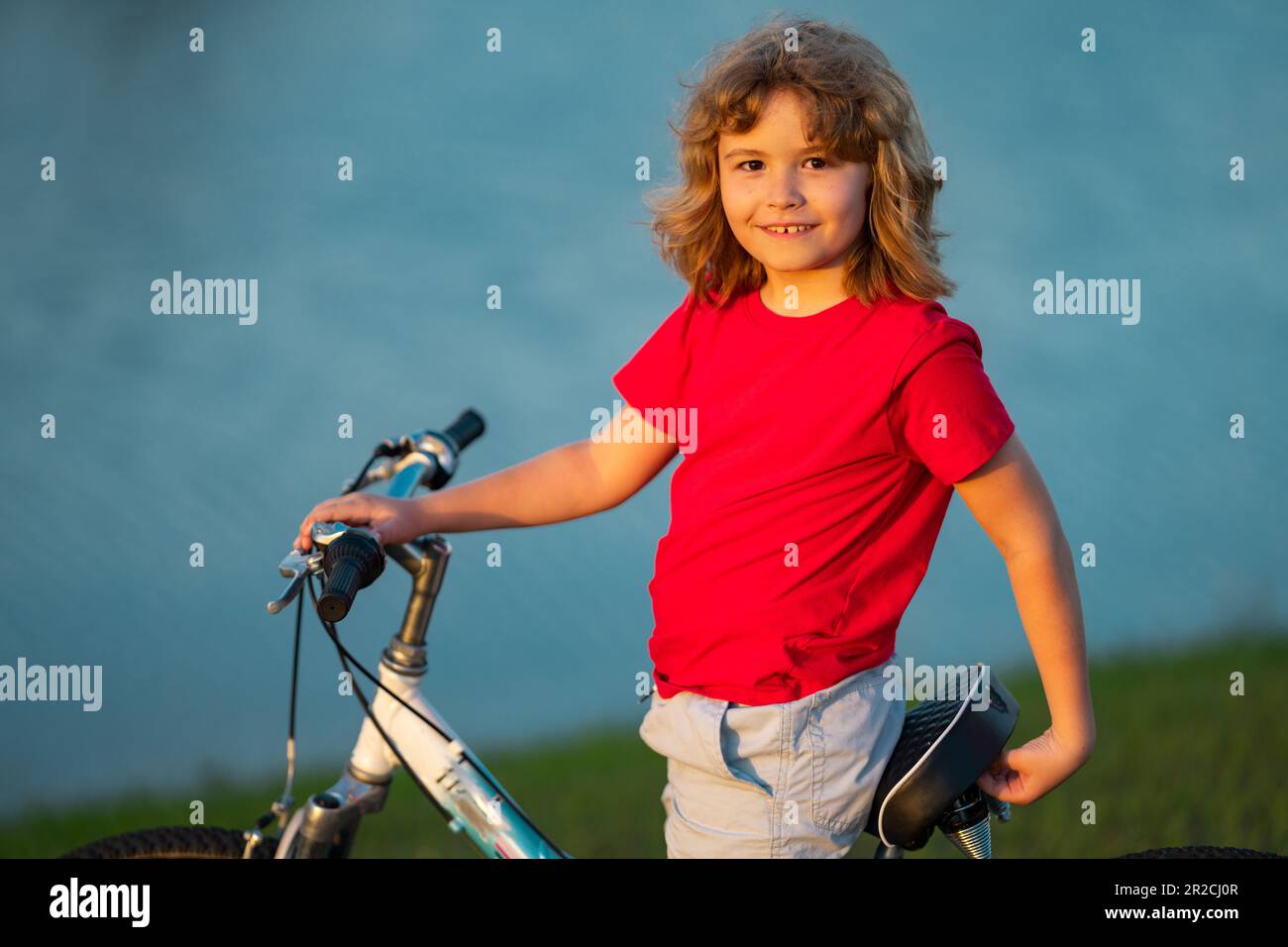 Little kid boy ride a bicycle in the park. Kid cycling on bicycle ...