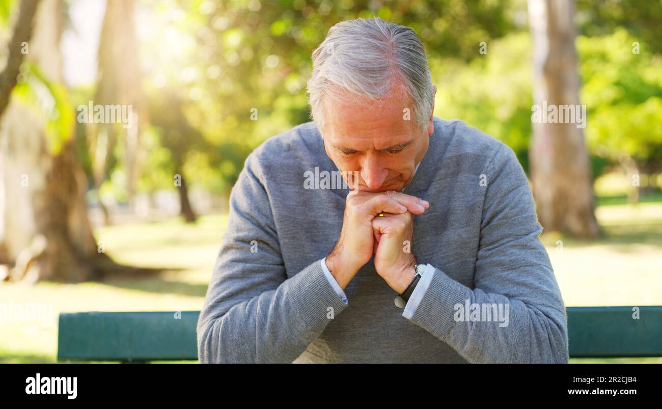 Worried man sitting alone outdoors hi-res stock photography and images ...