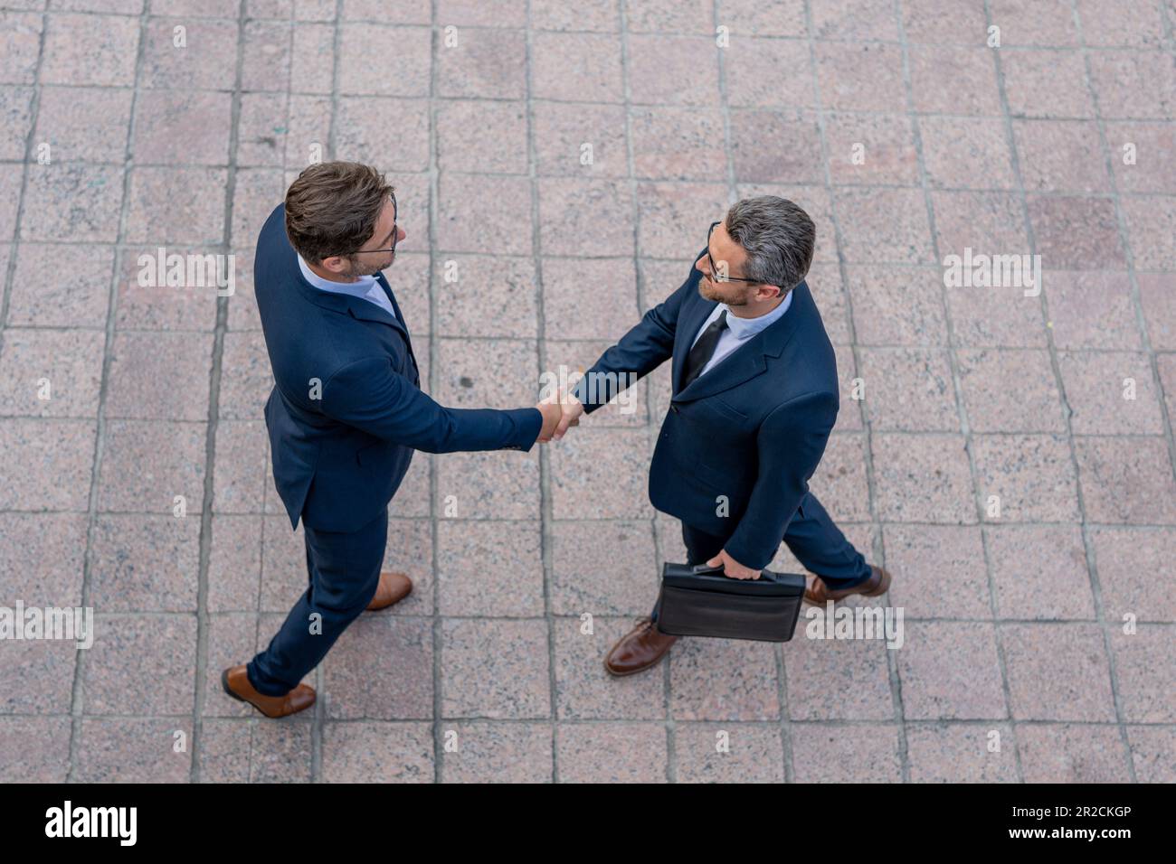 Business man shaking hands. Two businessmen handshake outdoor ...