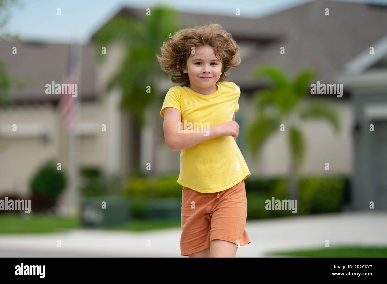 Excited Kid running in street. Amazed child enjoy run. Happy little boy ...