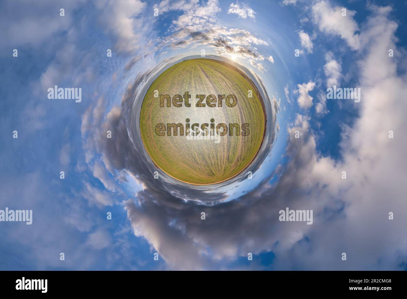 net zero emissions text concept image against green tiny planet in blue ...