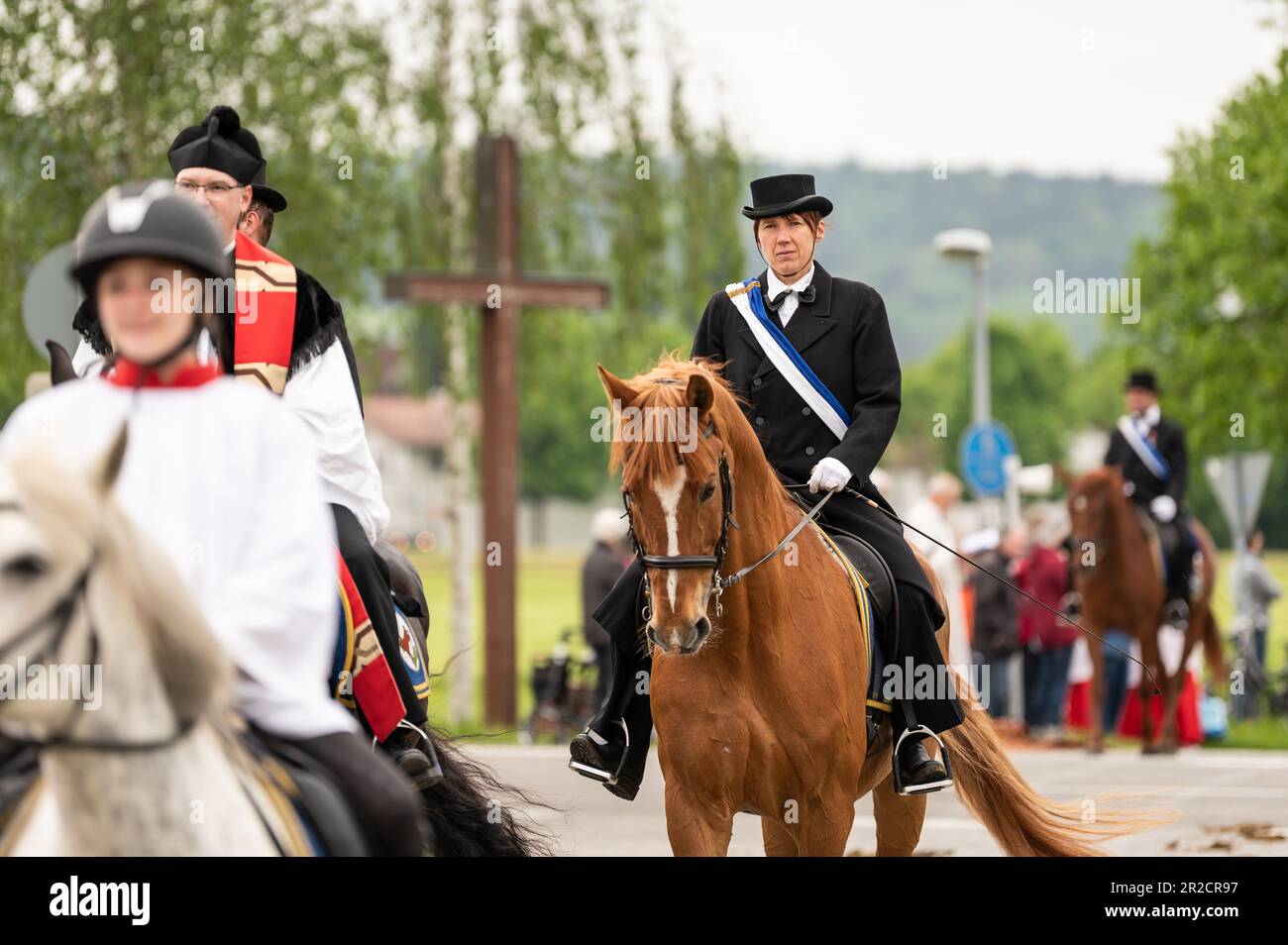 Weingarten, Germany. 19th May, 2023. A woman rides in the procession ...