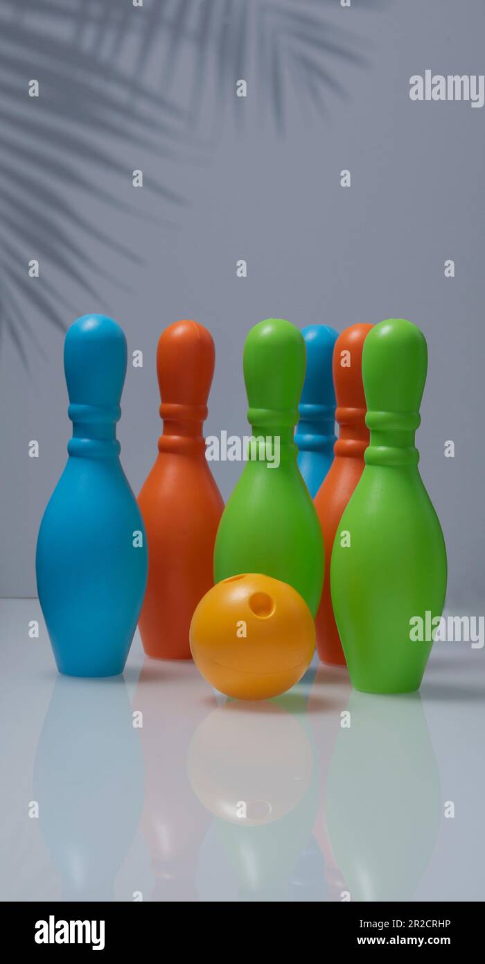Bowling pins .Childrens plastic set on the white mirror surface Stock ...