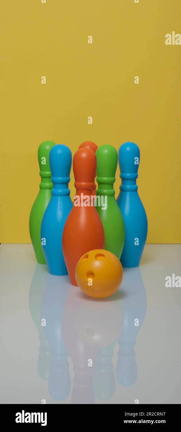 Bowling pins .Childrens plastic set on the white mirror surface Stock ...