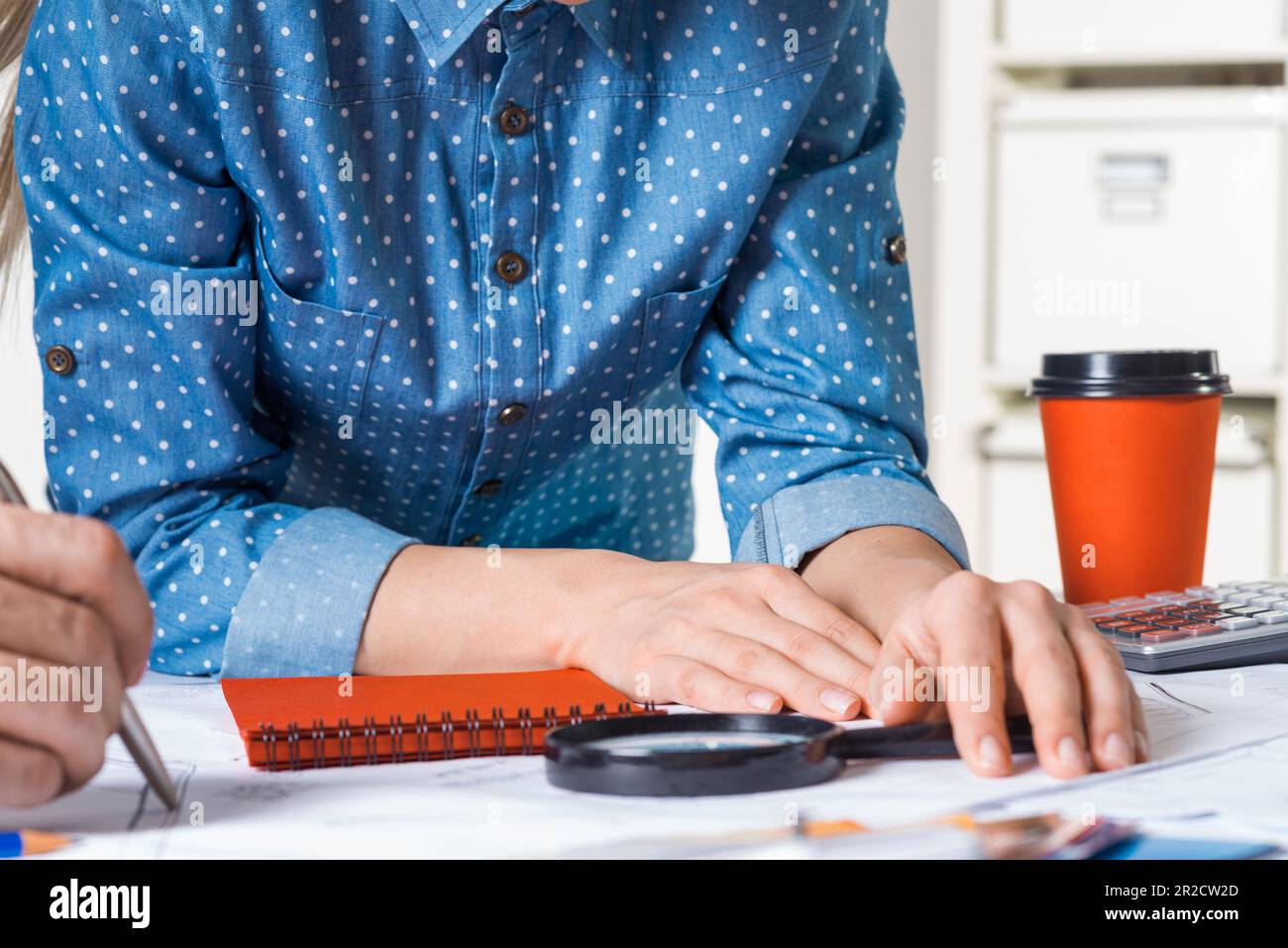 Architect standing near desk with blueprints Stock Photo - Alamy