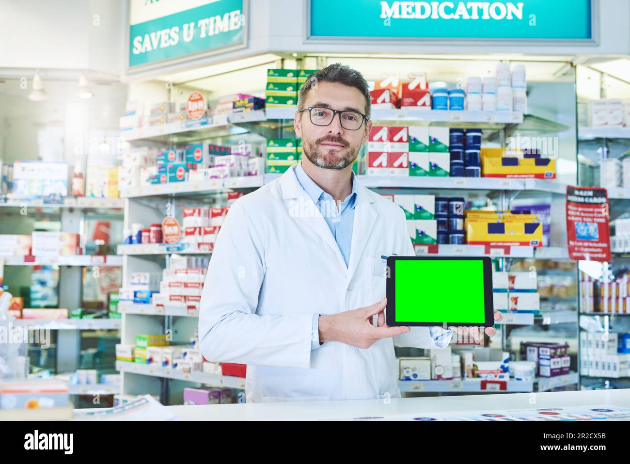 Man, pharmacist and tablet with green screen in store for product ...