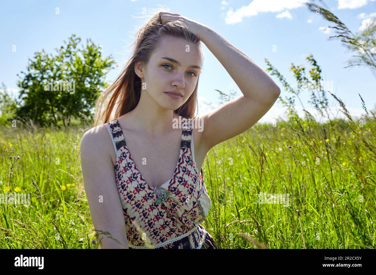 Beautiful model posing on summer field. Portrait of attractive young ...