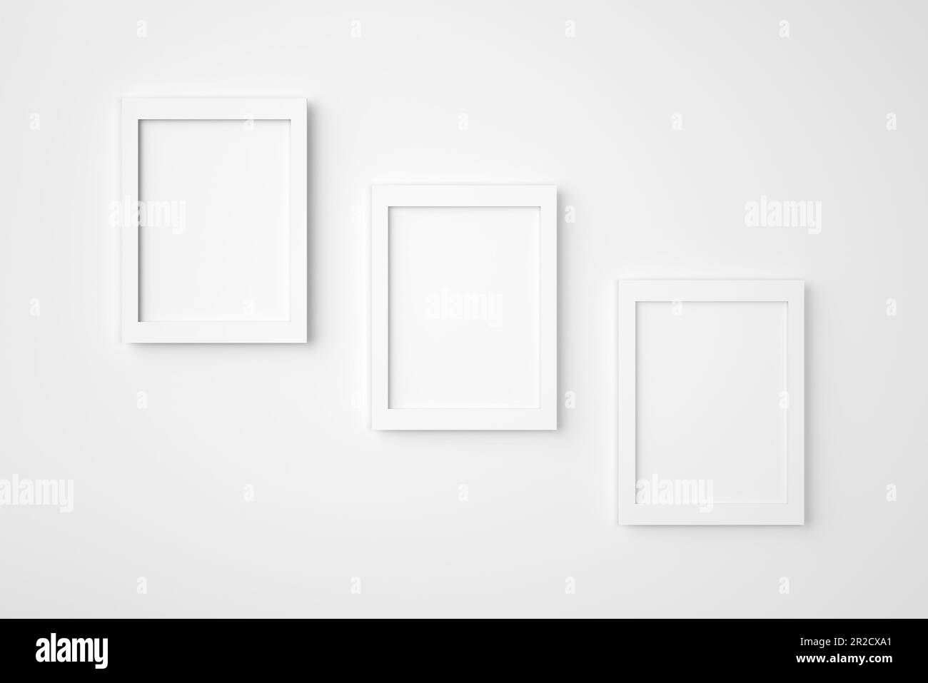 Three blank or empty rectangle picture frames hanging on white wall ...