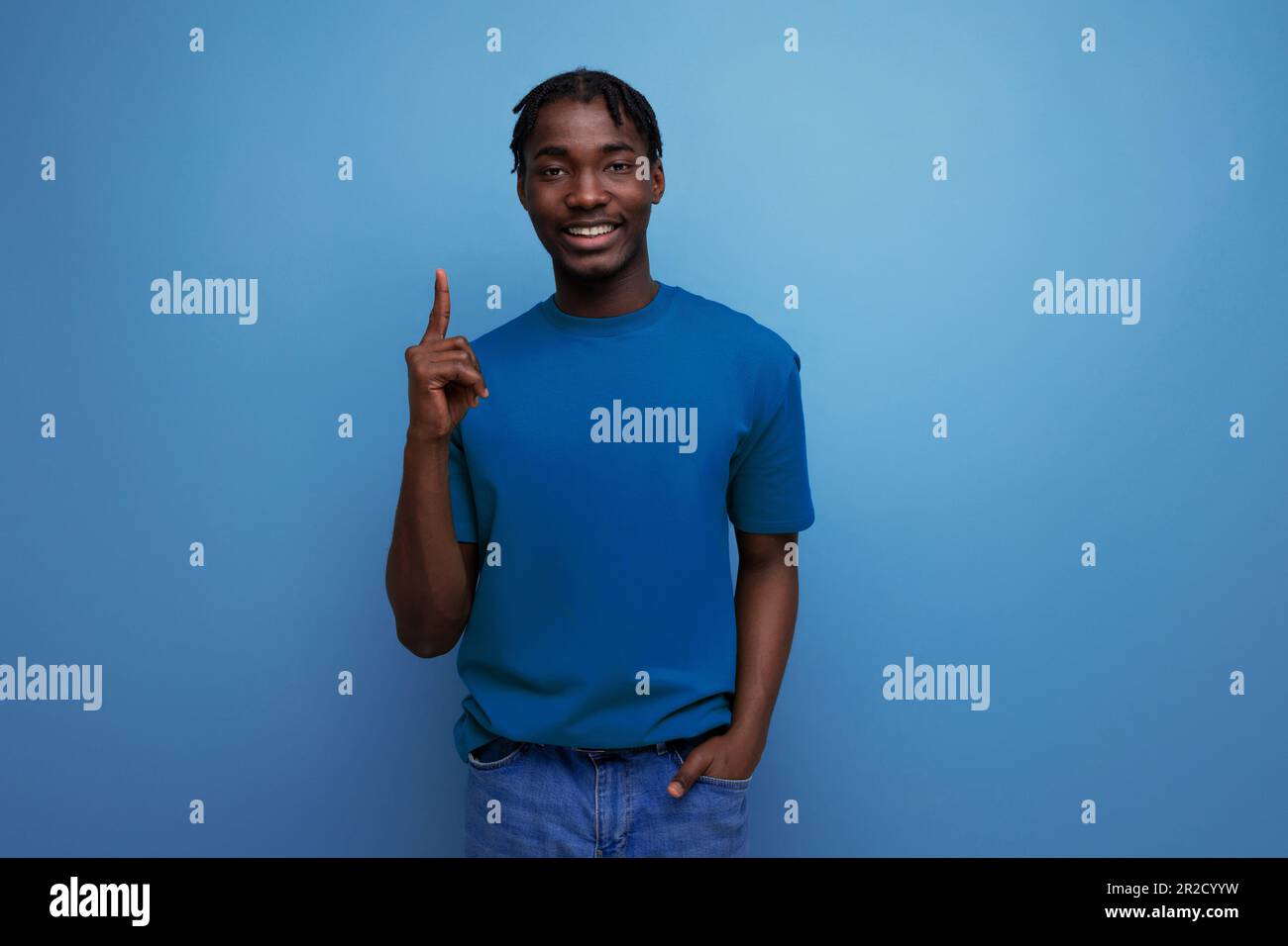 energetic young black american man pointing at wall over isolated ...