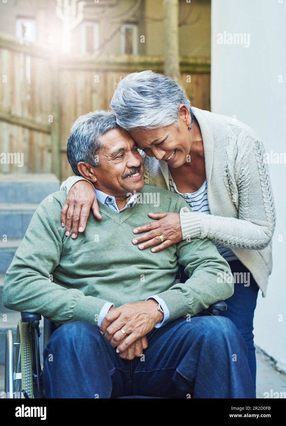 Disability, wheelchair and senior couple hug with care, support and ...