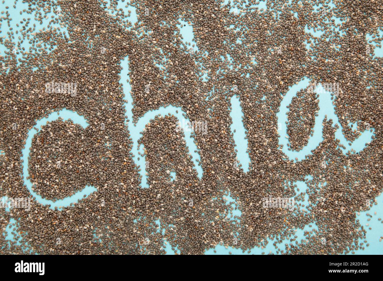 Word chia piled of chia seed on blue background Stock Photo - Alamy