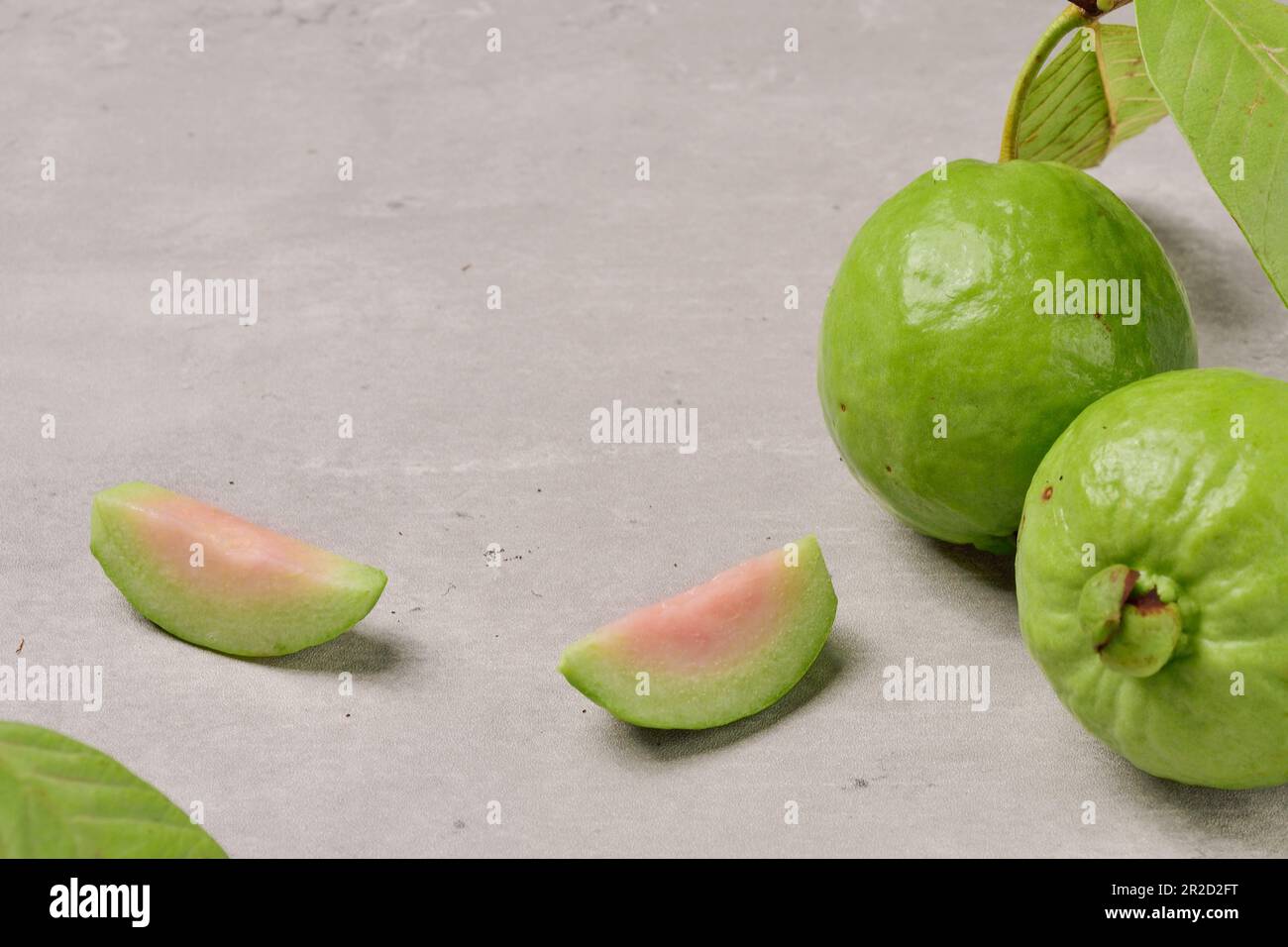 Pink guava fruits isolated on concrete background.Guava fruit with leaf ...