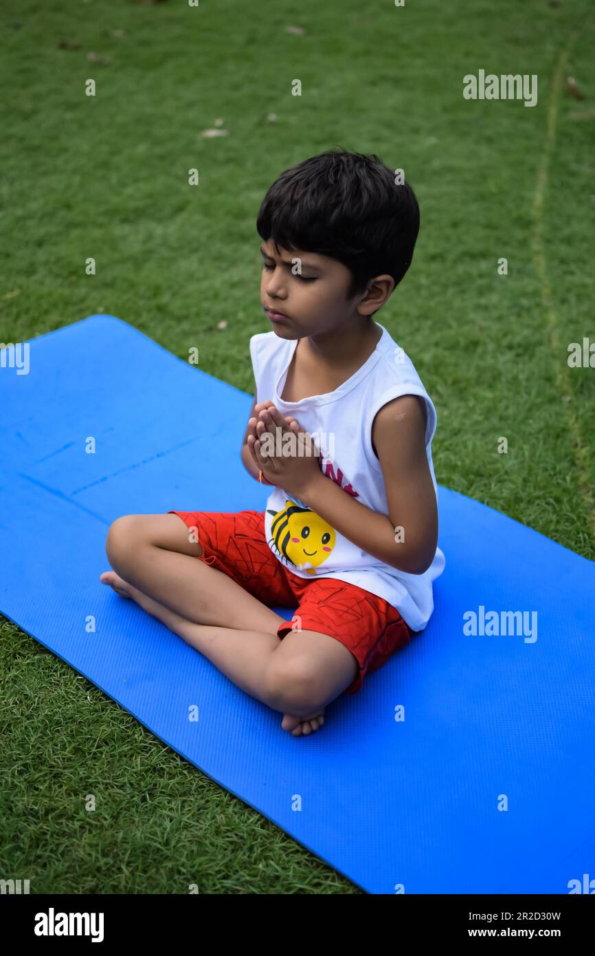 Asian smart kid doing yoga pose in the society park outdoor, Children's ...