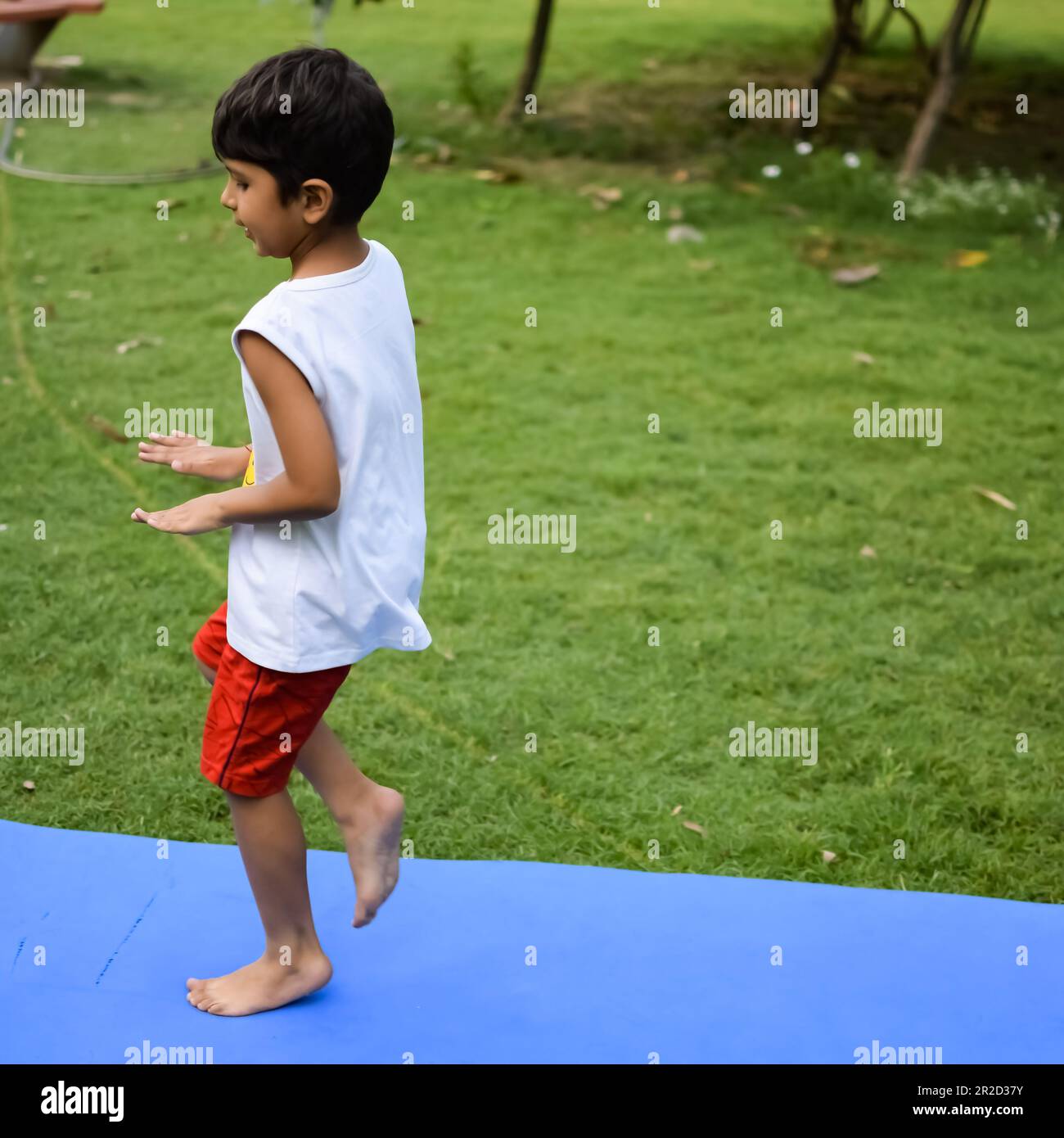 Asian smart kid doing yoga pose in the society park outdoor, Children's ...