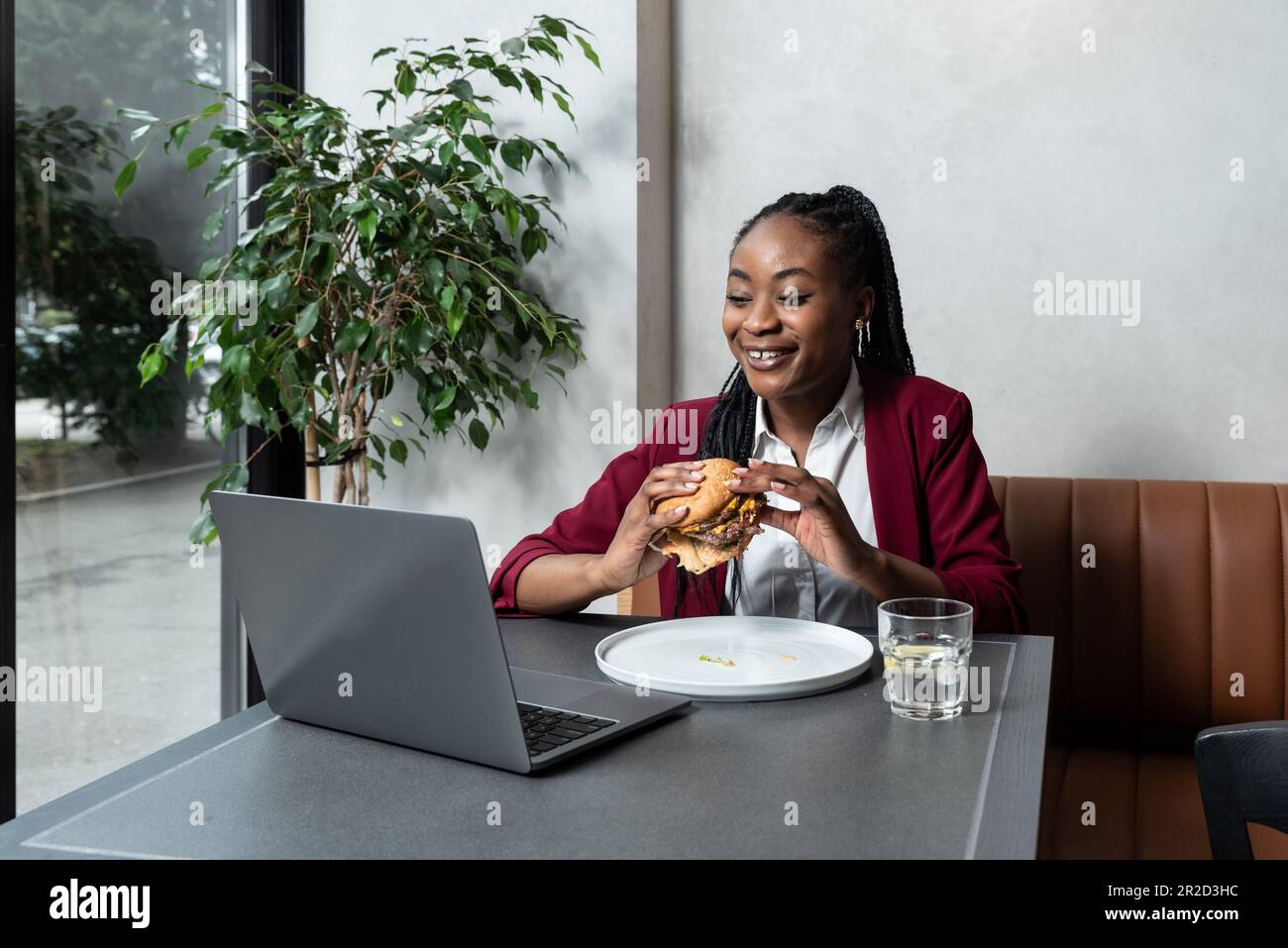Busy young professional business woman wearing suit using laptop ...