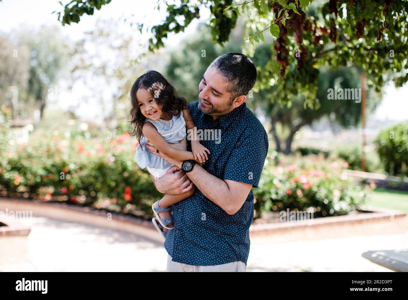 Father & Daughter Standing Under Tree Laughing & Smiling Stock Photo ...
