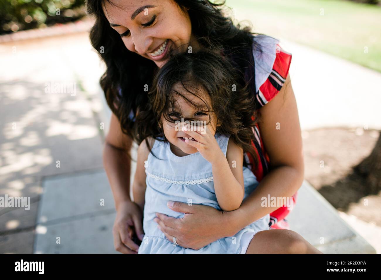 Mother & Daughter Smiling Under Tree While Wind Blows Stock Photo - Alamy