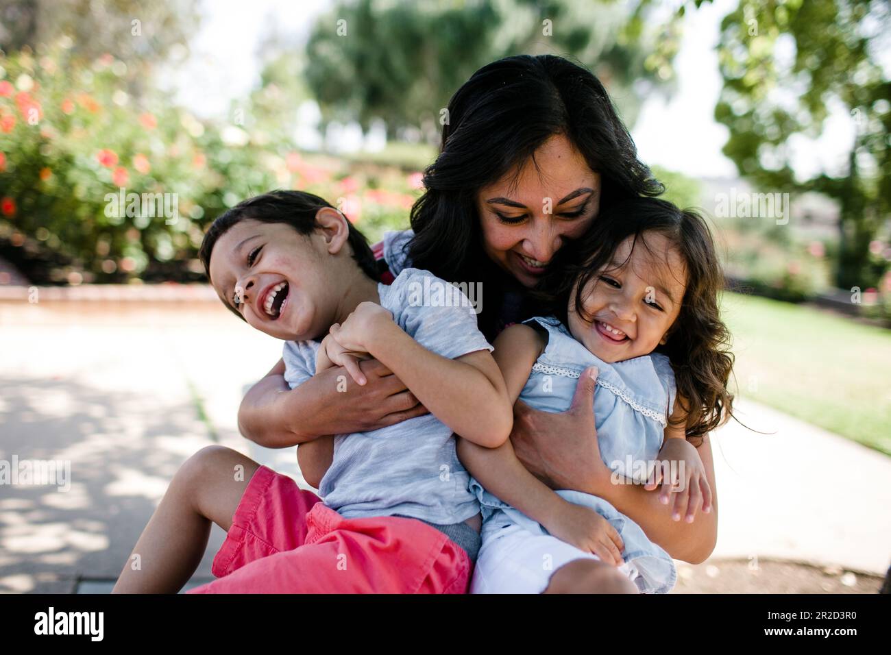 Mom Holding Son & Daughter Hugging & Laughing Stock Photo - Alamy
