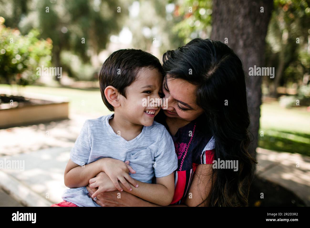 Mother & Autistic Son Smiling & Hugging Under Tree Stock Photo - Alamy