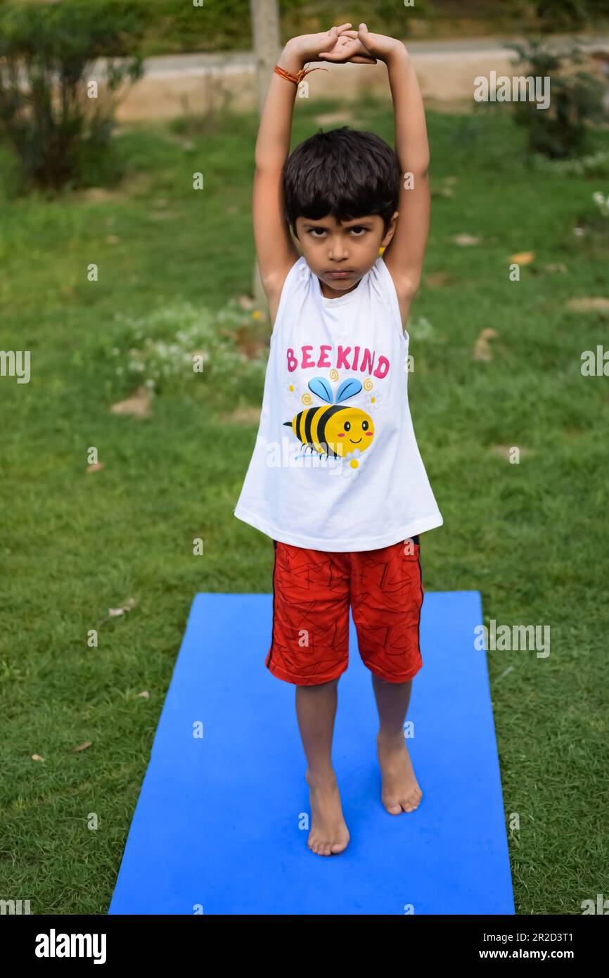 Asian smart kid doing yoga pose in the society park outdoor, Children's ...