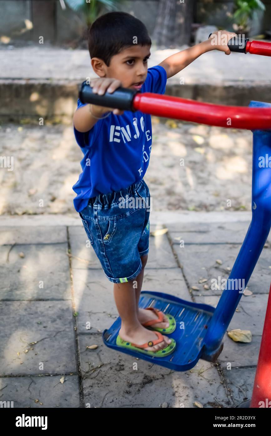 Asian boy doing routine exercise in society park during the morning ...