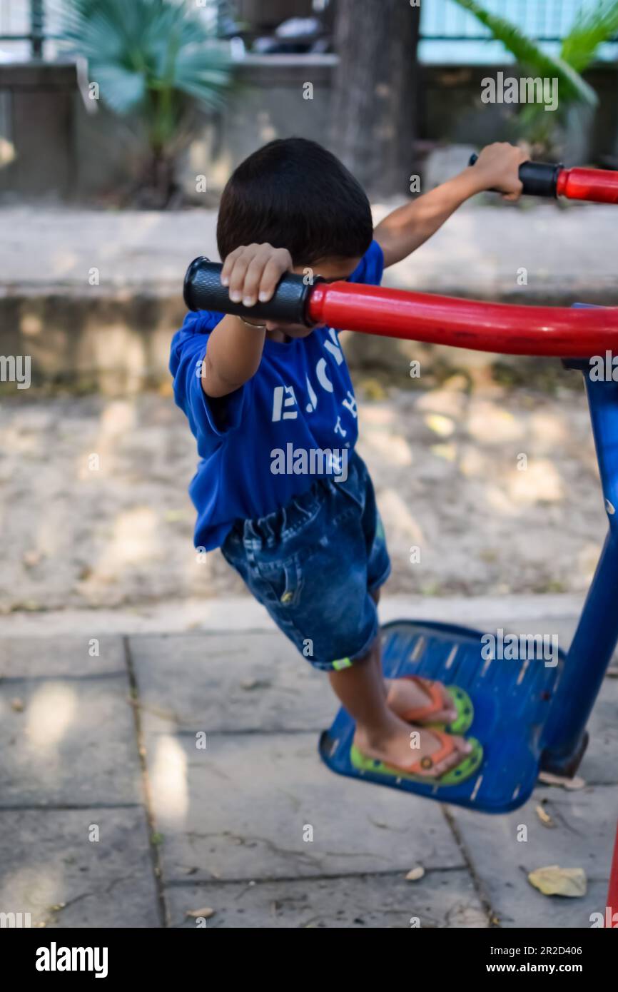 Asian boy doing routine exercise in society park during the morning ...
