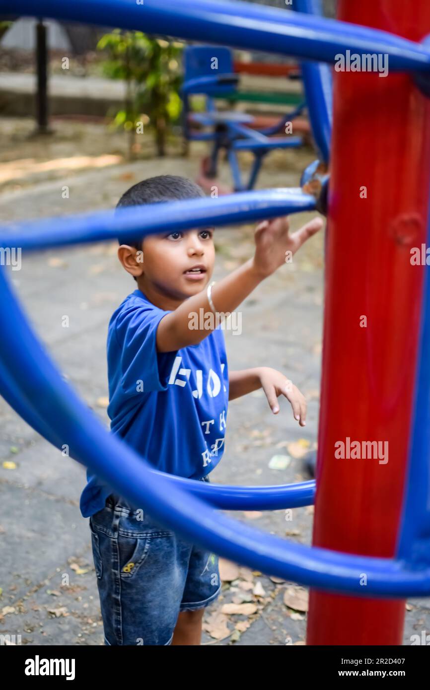 Asian boy doing routine exercise in society park during the morning ...