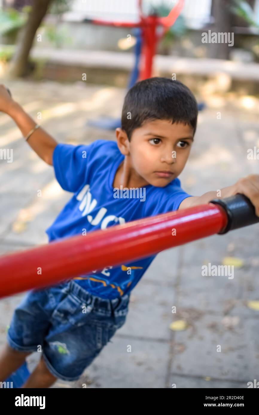 Asian boy doing routine exercise in society park during the morning ...