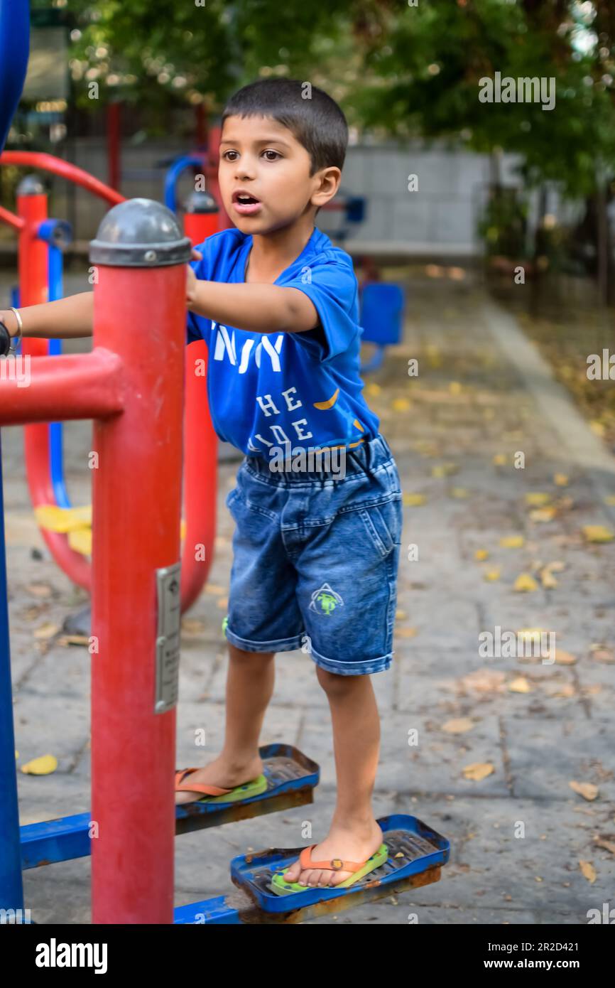 Asian boy doing routine exercise in society park during the morning ...