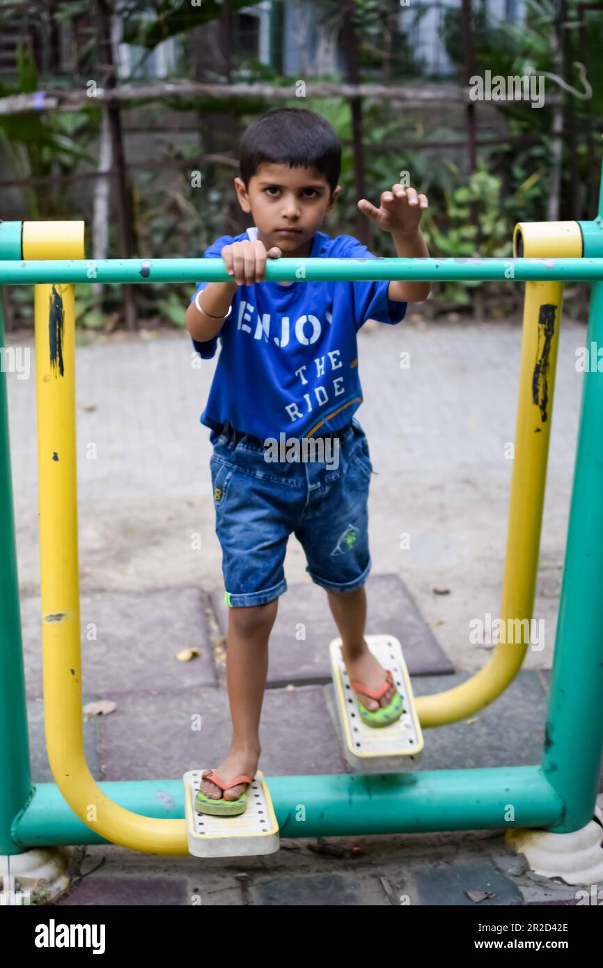 Asian boy doing routine exercise in society park during the morning ...