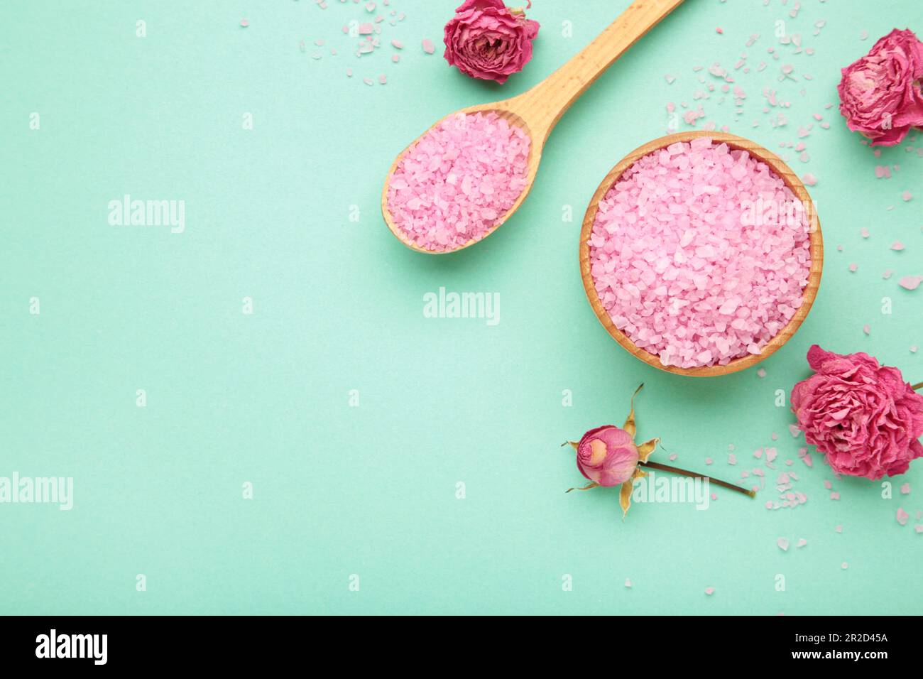 Pink salt with roses on mint background.. Top view Stock Photo - Alamy