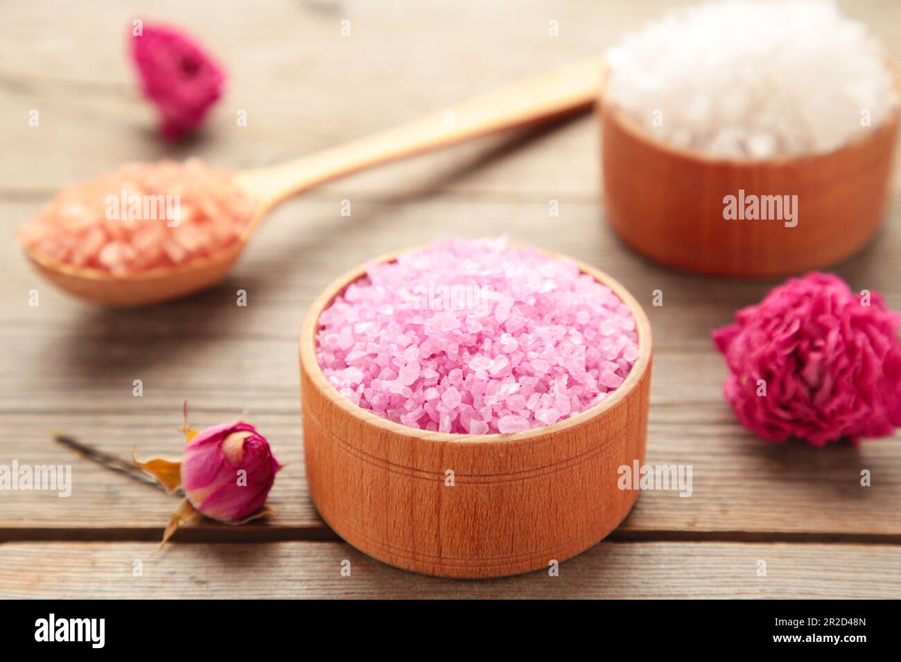 Different types of salt with roses on grey background.. Top view Stock ...