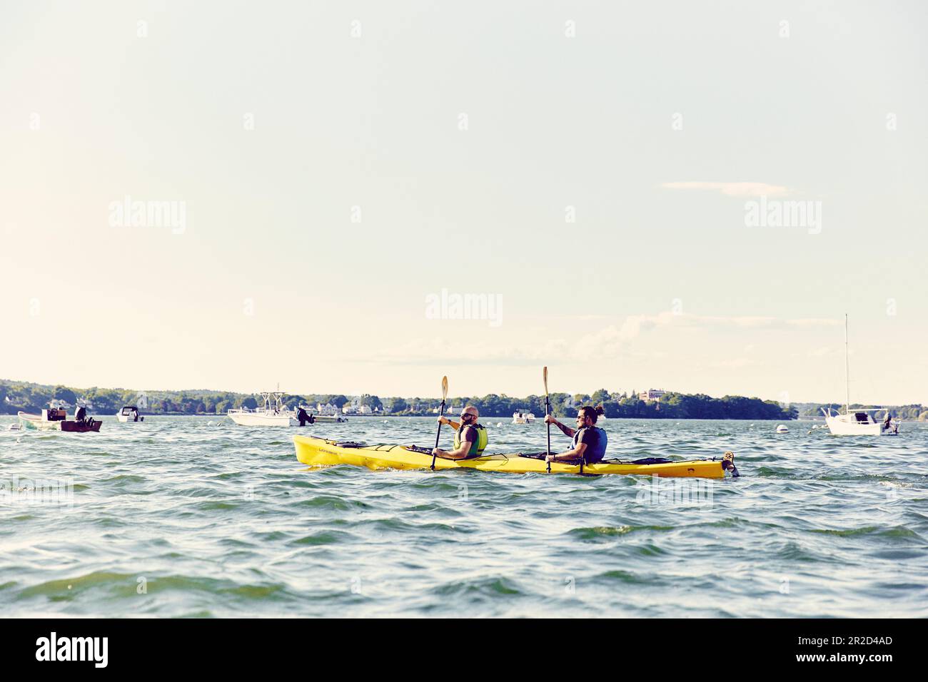 Two male friends in tandem kayak at sunset in Casco Bay, Maine Stock ...