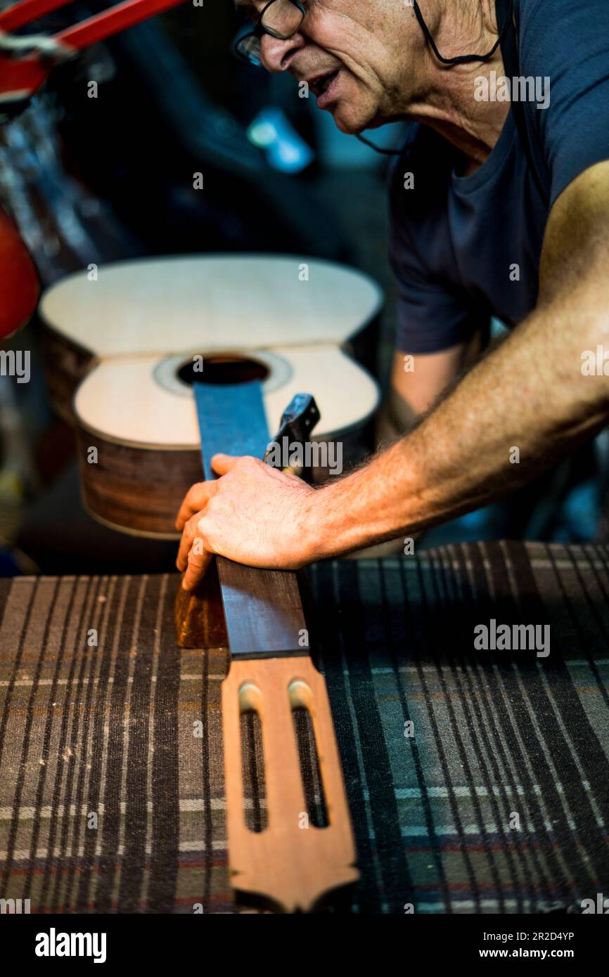 Luthier man making guitars in artisan workshop in Spain Stock Photo - Alamy