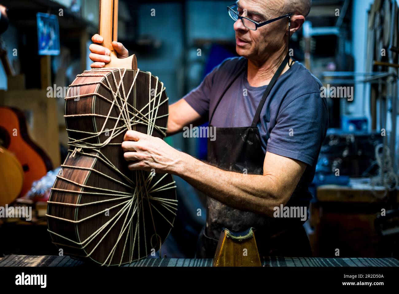 Luthier man making guitars in artisan workshop in Spain Stock Photo - Alamy
