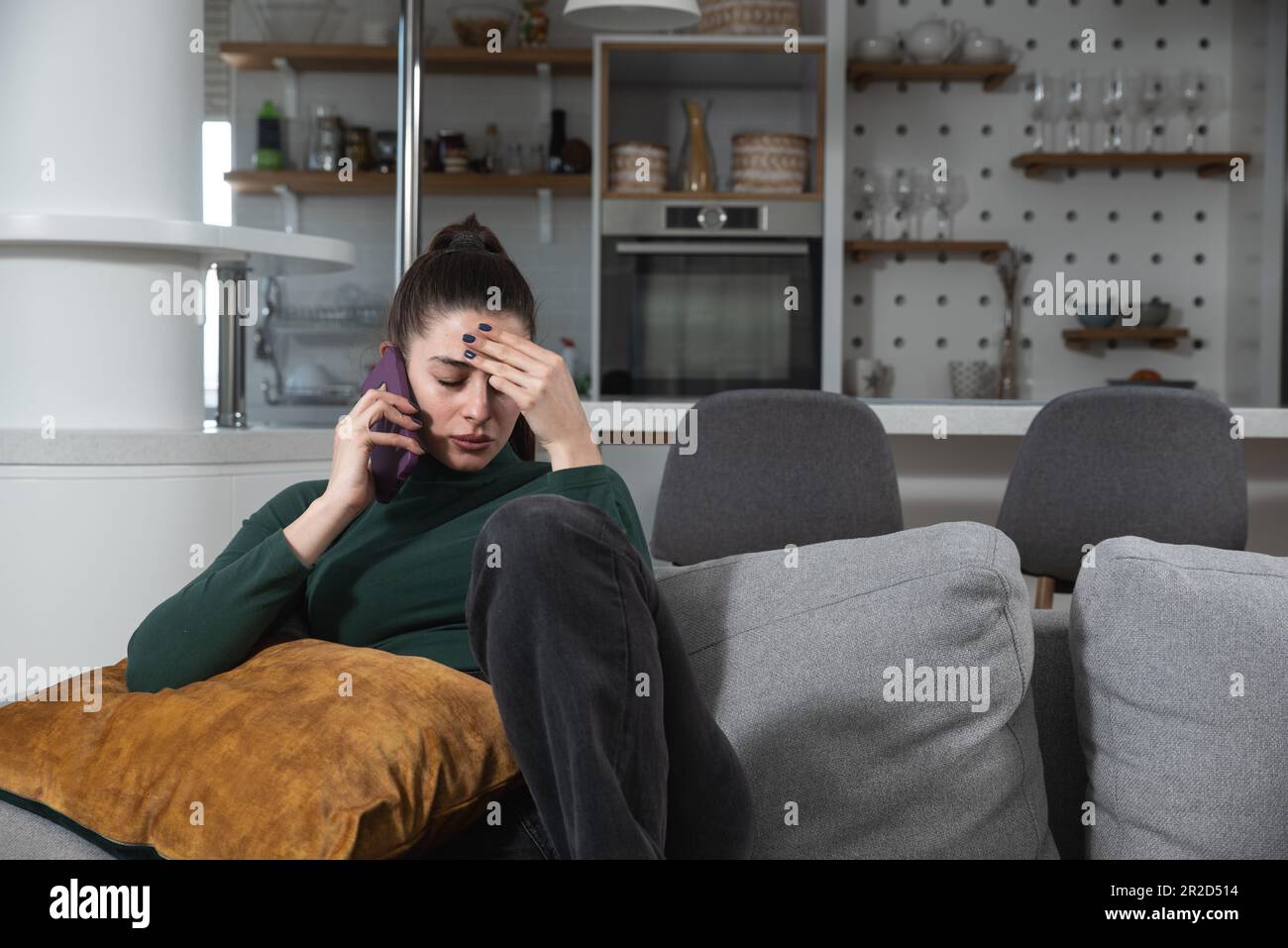 Sad millennial woman has difficult phone talk hold gadget by ear listen ...