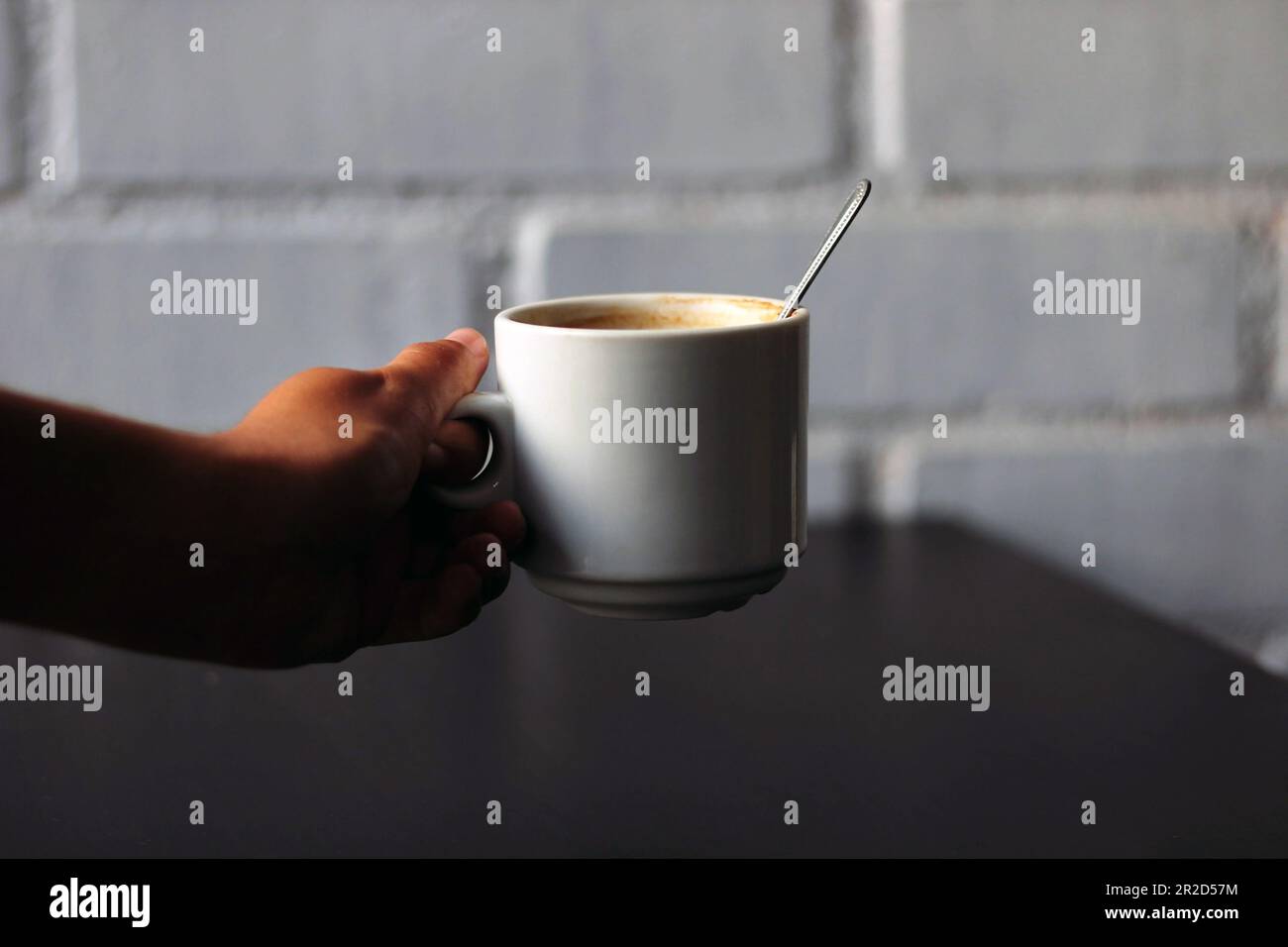 Hand picking up cup hi-res stock photography and images - Alamy